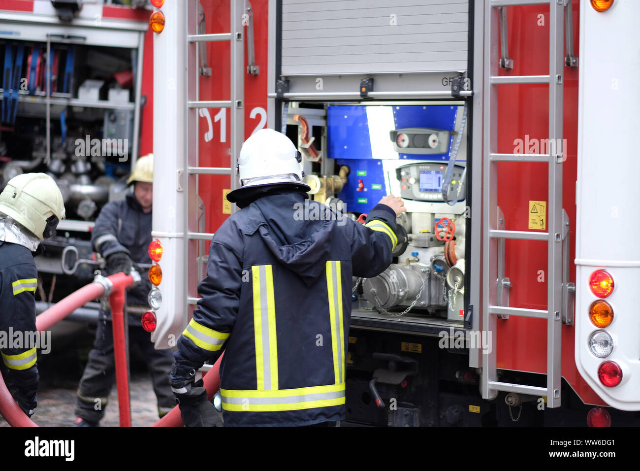 Brigade firefighters deploys equipment for fire extinguishing Stock ...