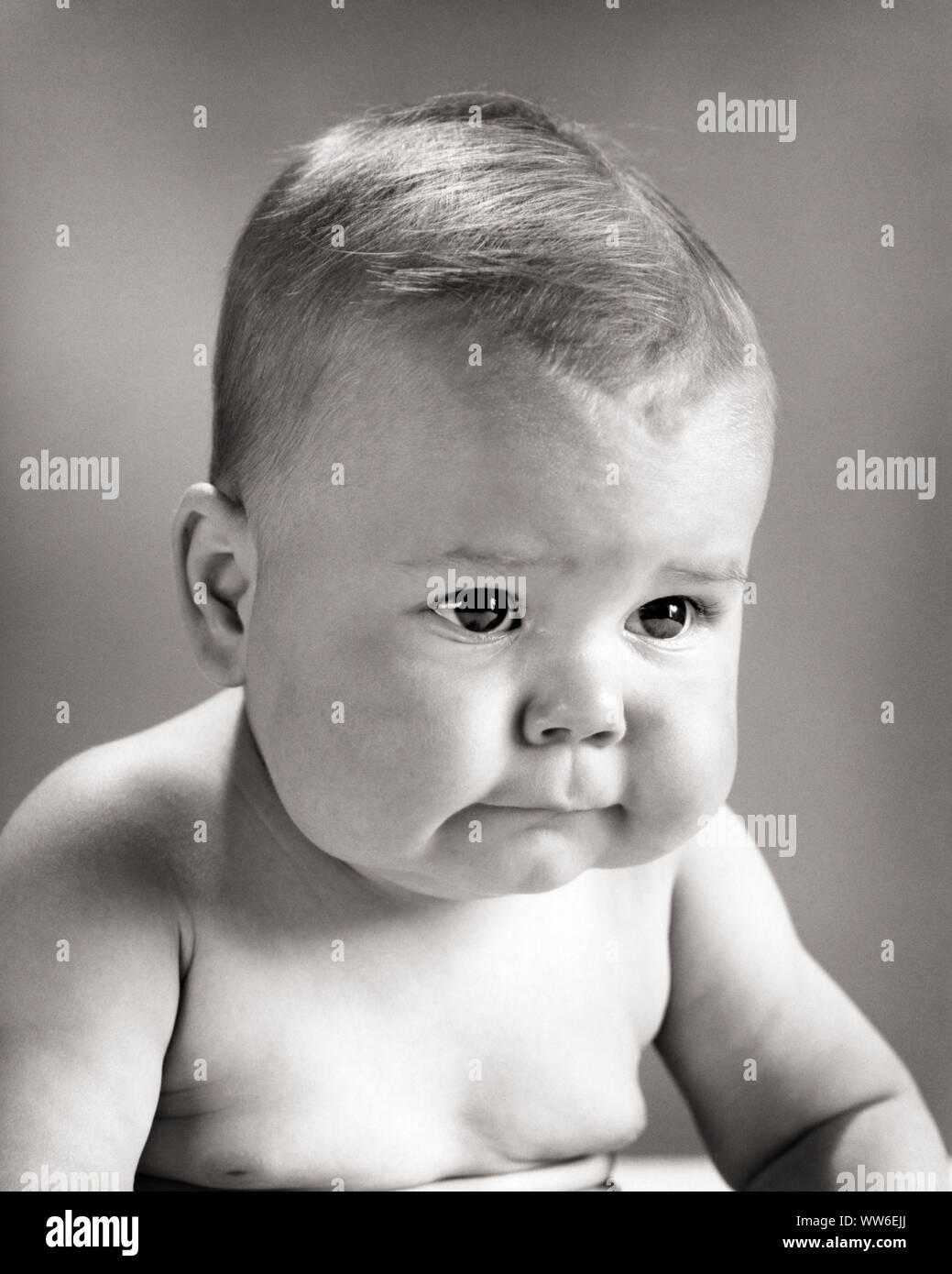 1960s BABY WITH SERIOUS FACIAL EXPRESSION LOOKING DOWN - b23150 HAR001 ...