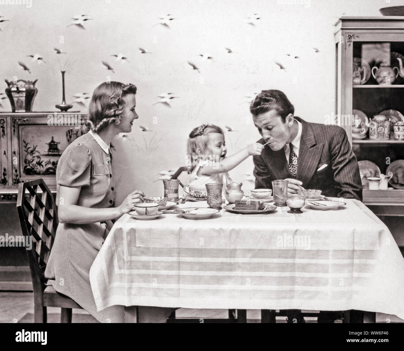 1930s 1940s FAMILY MOTHER FATHER DAUGHTER AT DINING TABLE LITTLE GIRL ...