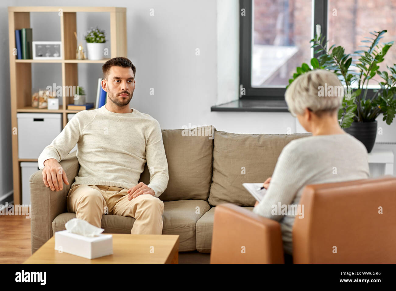Doctor man taking notes listening hi-res stock photography and images ...