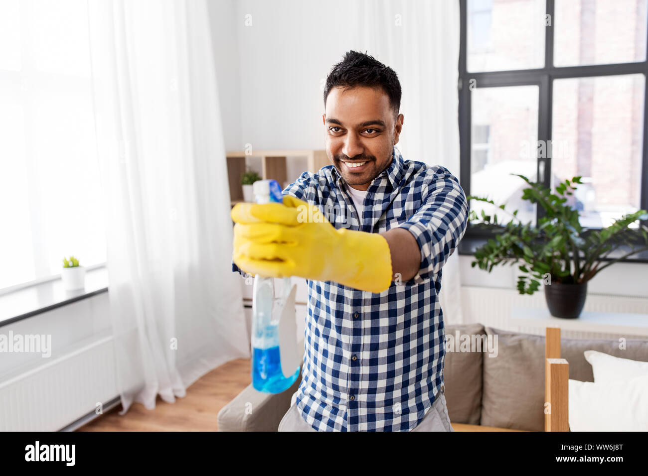 smiling indian man with detergent cleaning at home Stock Photo - Alamy