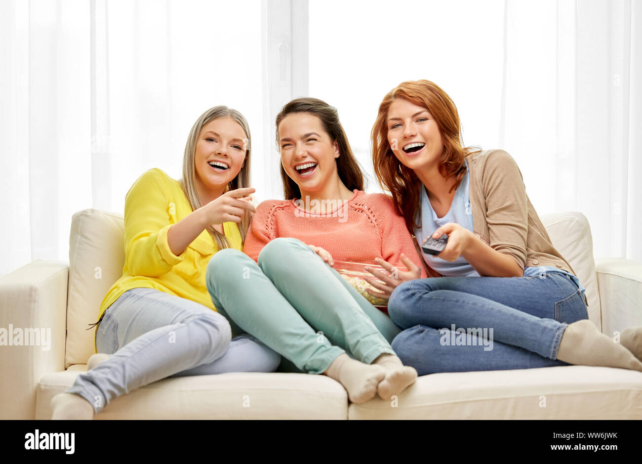 teenage girls or friends watching tv at home Stock Photo - Alamy