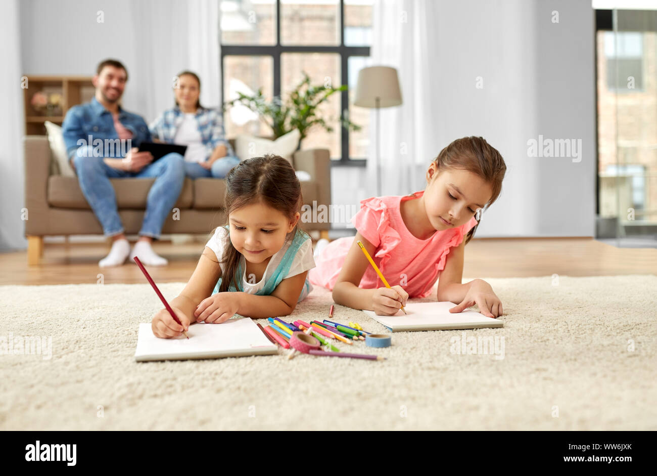happy sisters drawing in sketchbooks at home Stock Photo - Alamy