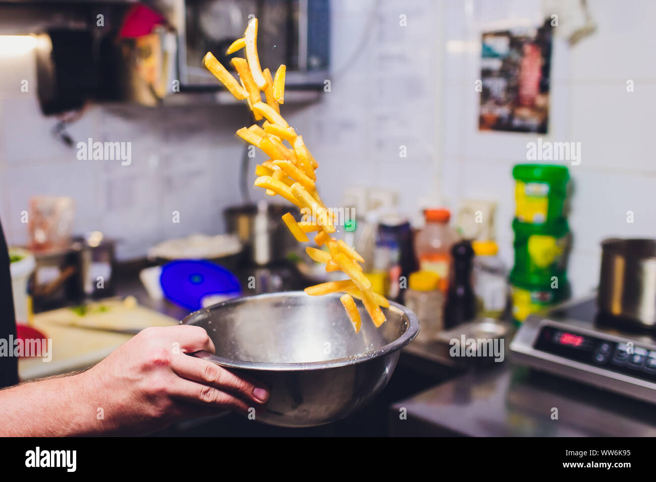 Female chef preparing french fries in kitchen Stock Photo - Alamy