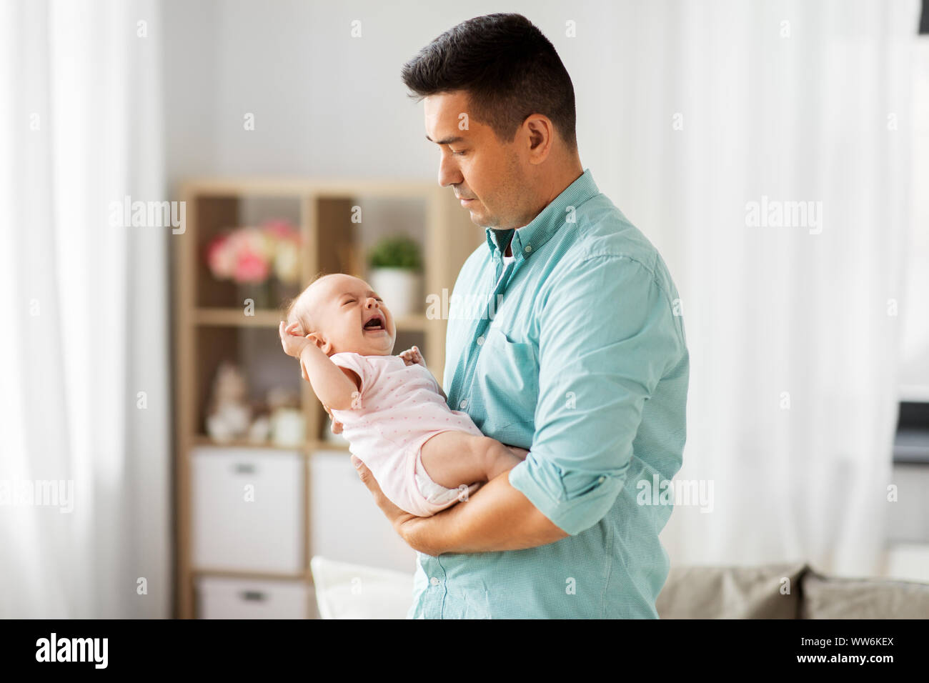 middle aged father with baby daughter at home Stock Photo - Alamy