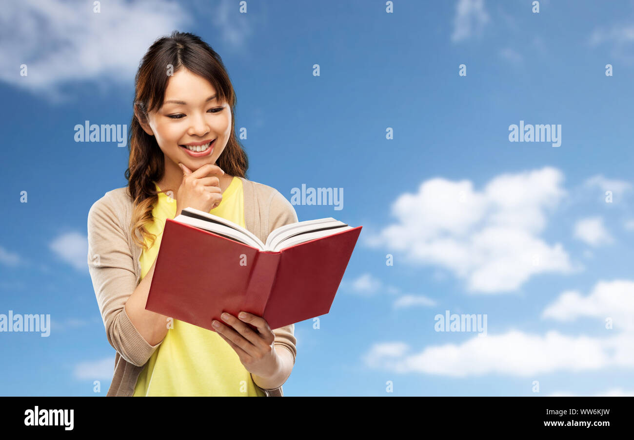 happy asian woman reading book Stock Photo - Alamy