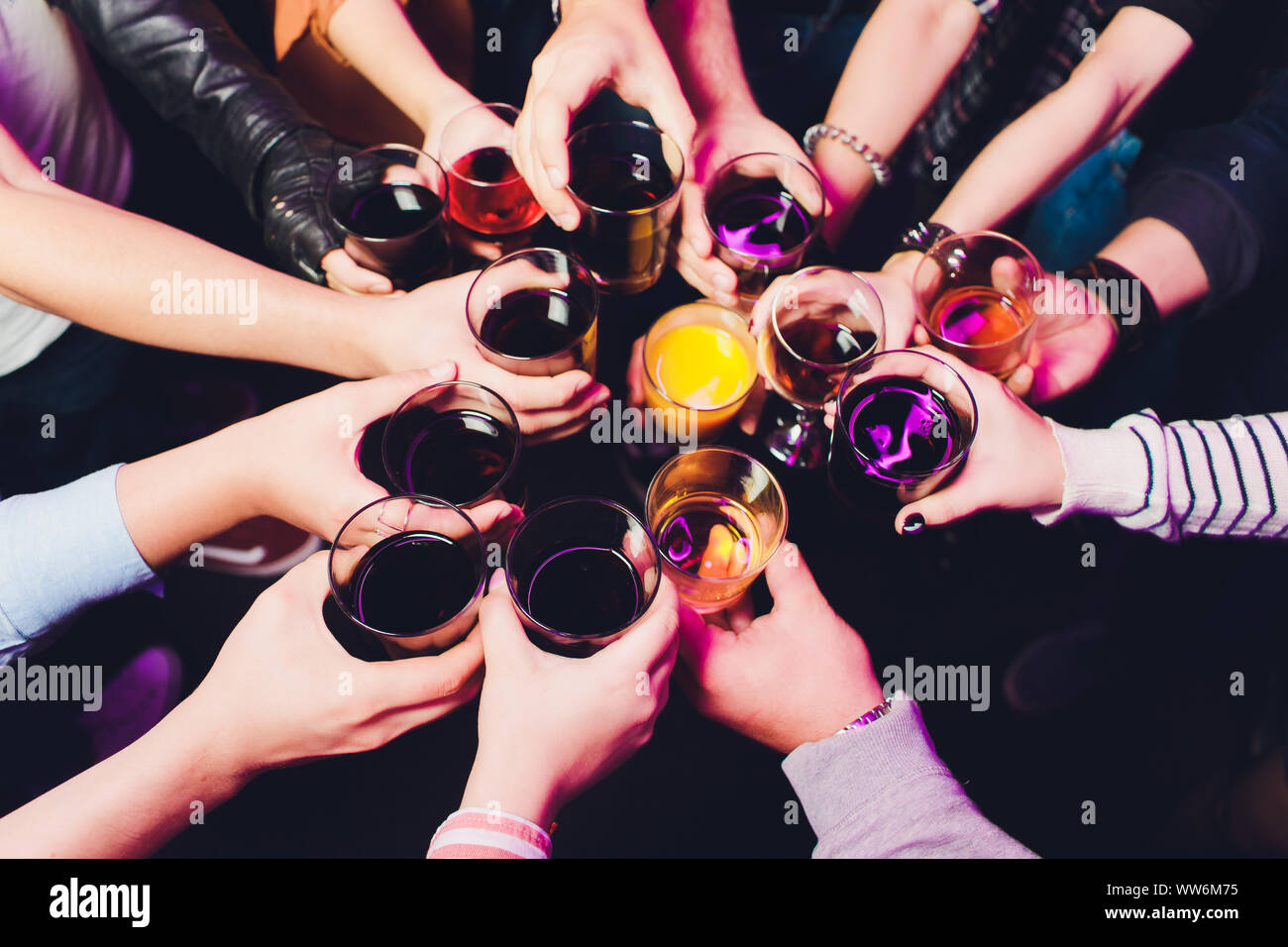 Clinking glasses with alcohol and toasting, party. Congratulations to ...