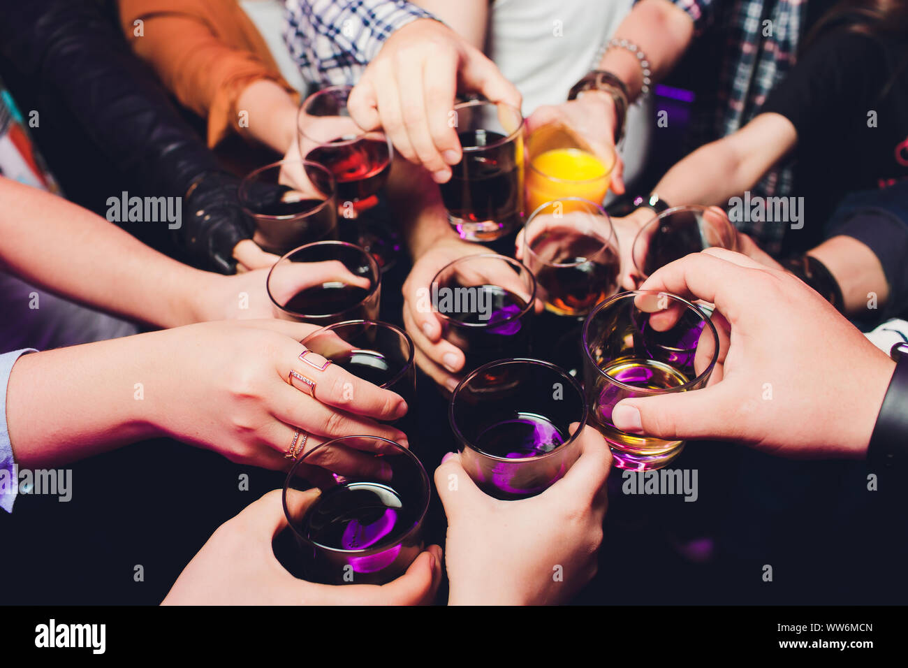 Clinking glasses with alcohol and toasting, party. Congratulations to ...