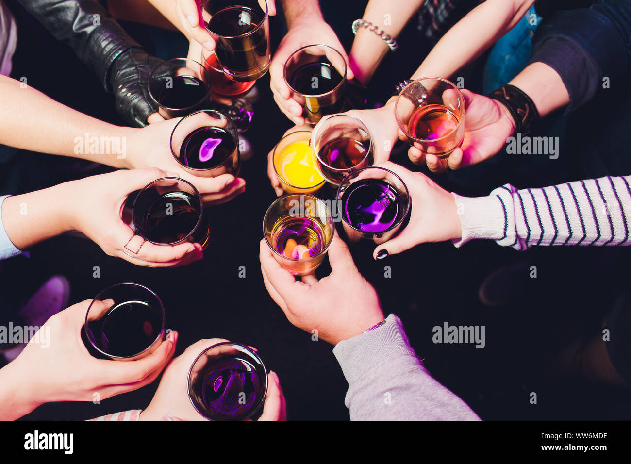 Clinking glasses with alcohol and toasting, party. Congratulations to ...