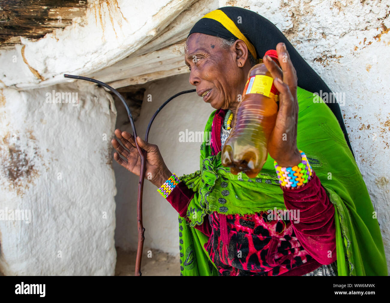 Oromo pilgrim woman with holy water in a bottle in the shrine of the ...