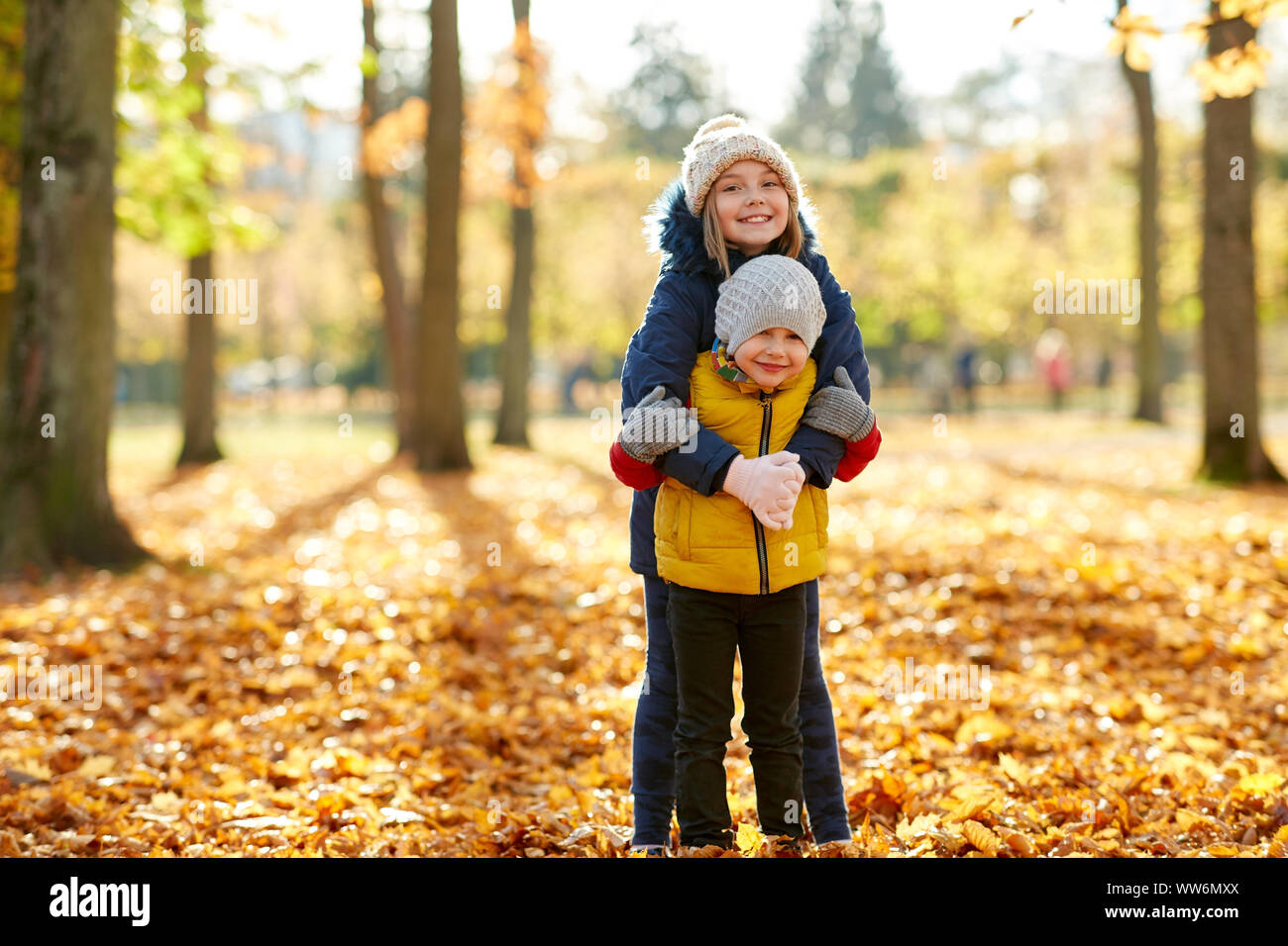 happy children hugging at autumn park Stock Photo - Alamy