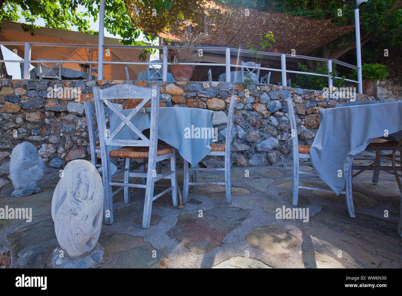 Tables and chairs from the restaurant in Greece Stock Photo - Alamy