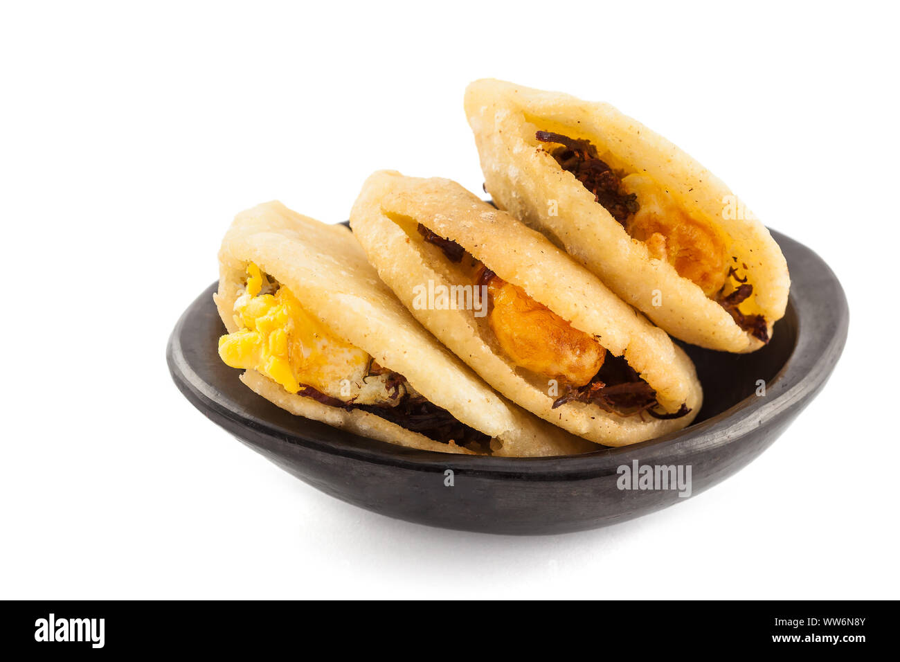 Arepa de huevo. Traditional Colombian fried arepa filled with egg and ...