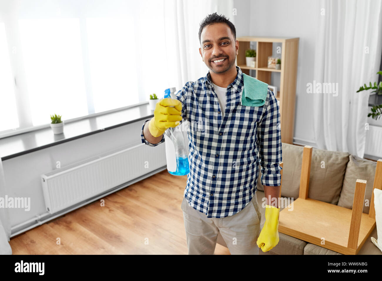 smiling indian man with detergent cleaning at home Stock Photo - Alamy