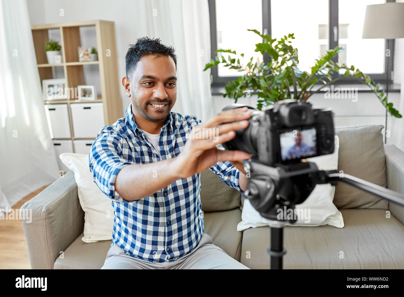 Man adjusting camera and tripod hi-res stock photography and images - Alamy