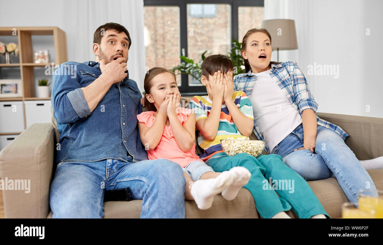 scared family with popcorn watching horror on tv Stock Photo - Alamy