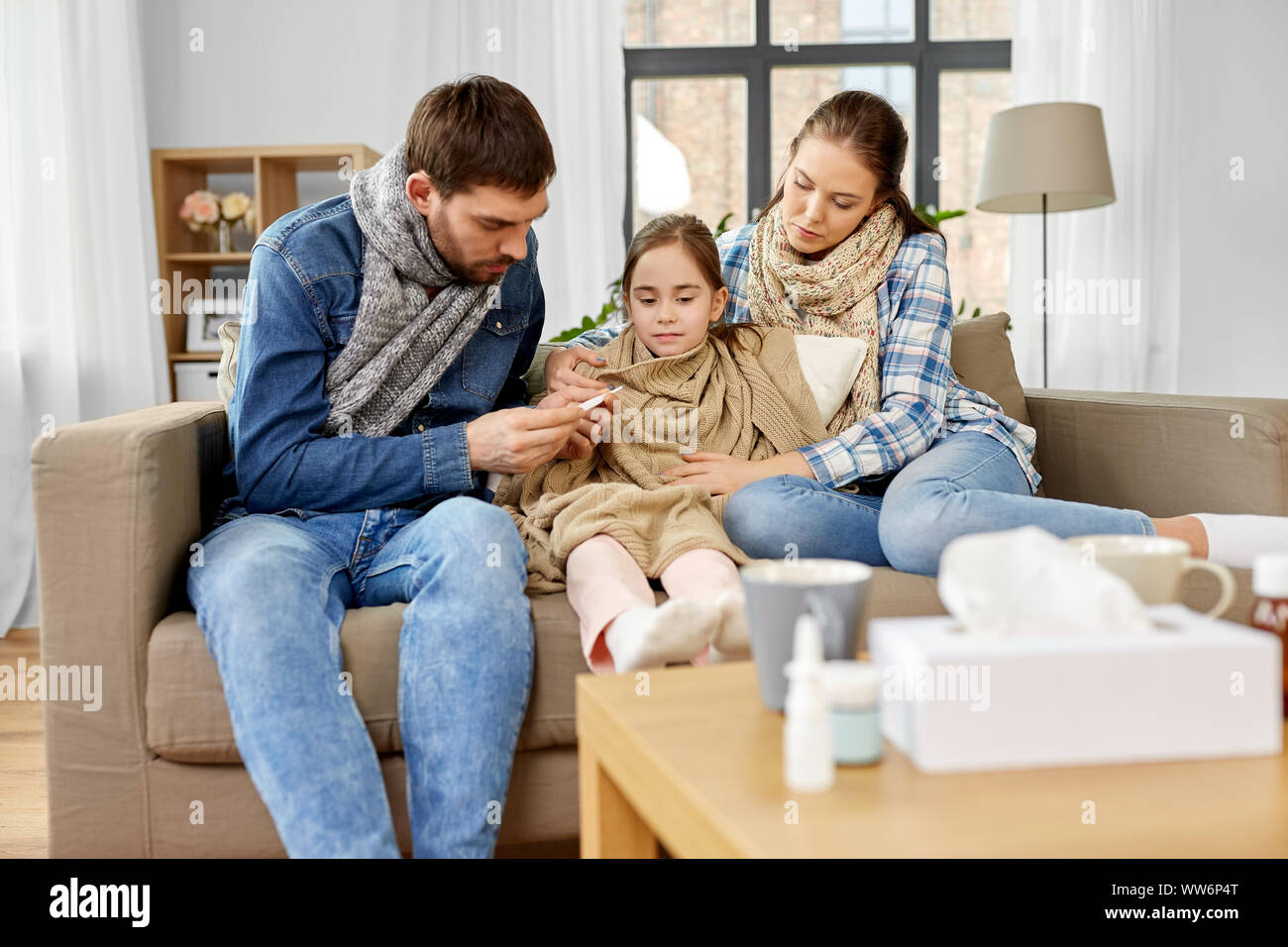 family with ill daughter having fever at home Stock Photo - Alamy