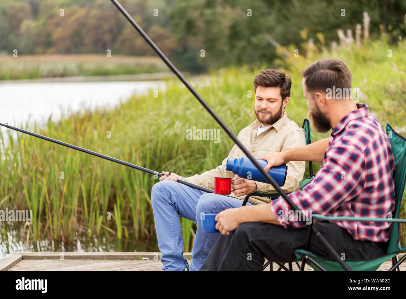 friends fishing and drinking tea from thermos Stock Photo - Alamy