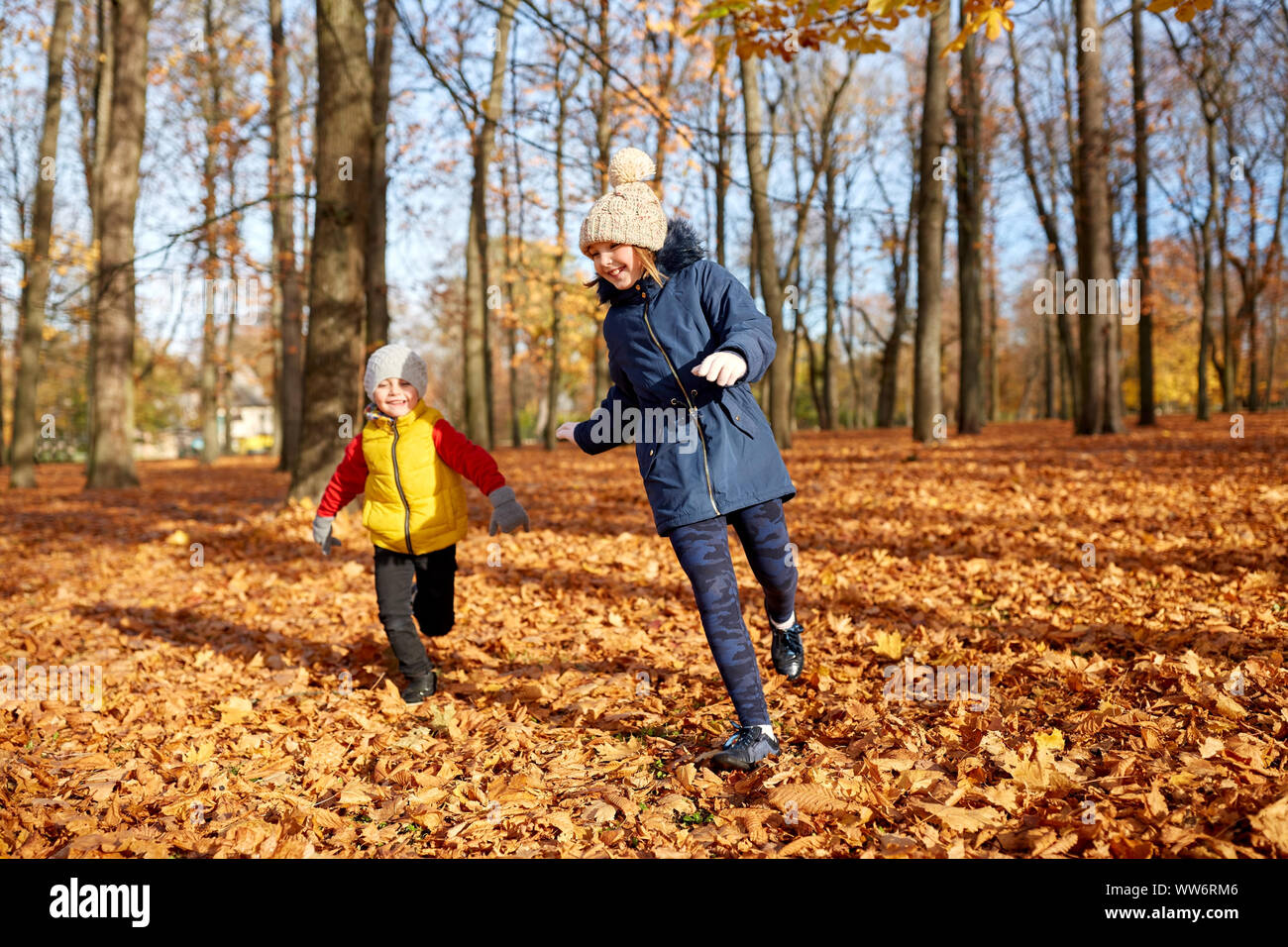 happy children running at autumn park Stock Photo - Alamy
