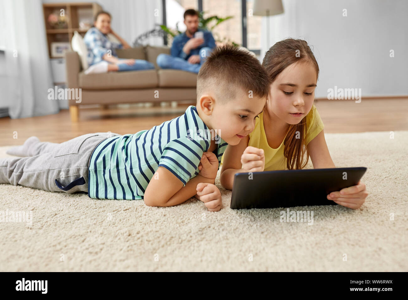 brother and sister with tablet computer at home Stock Photo - Alamy