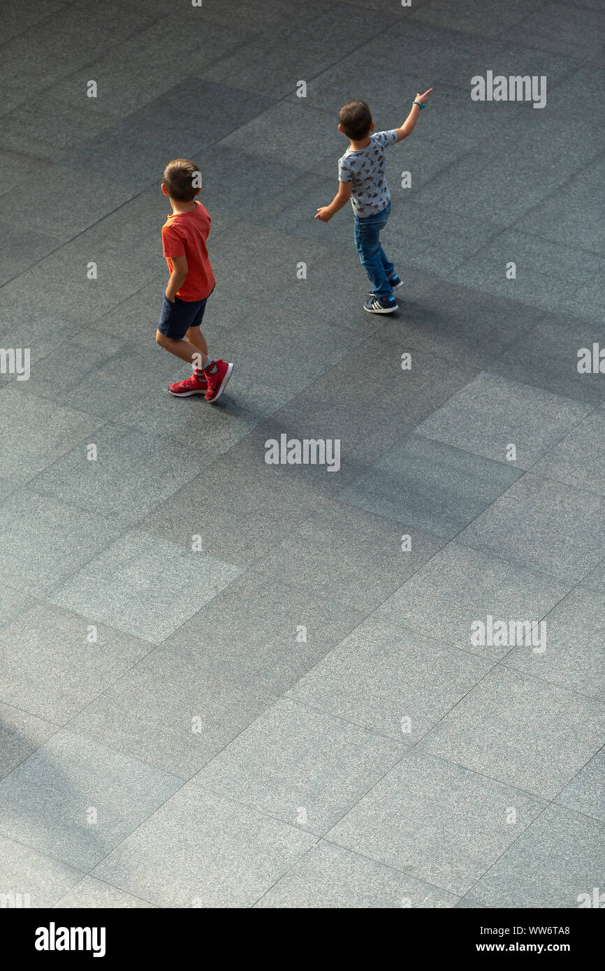 Two boys running in train station Stock Photo - Alamy
