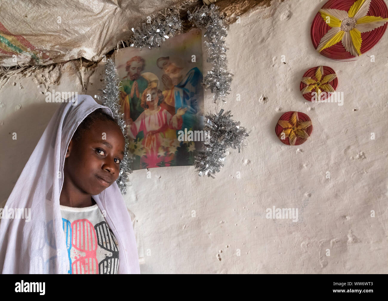 Eritrean Kunama tribe teenage girl in front of a religious poster, Gash ...
