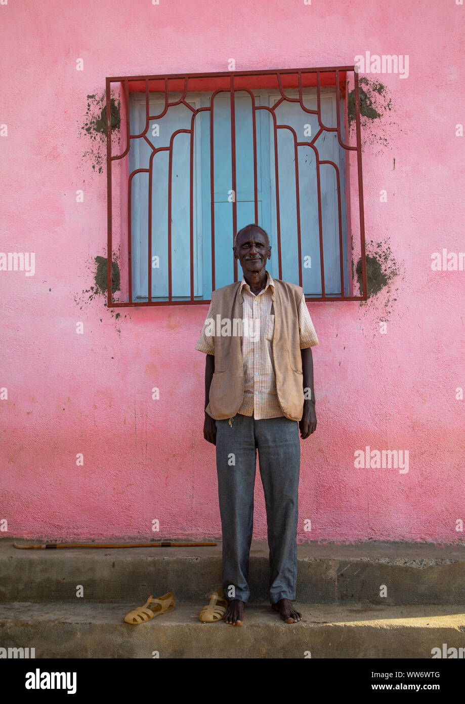 Eritrean man standing in front of a pink wall, Gash-Barka, Agordat ...
