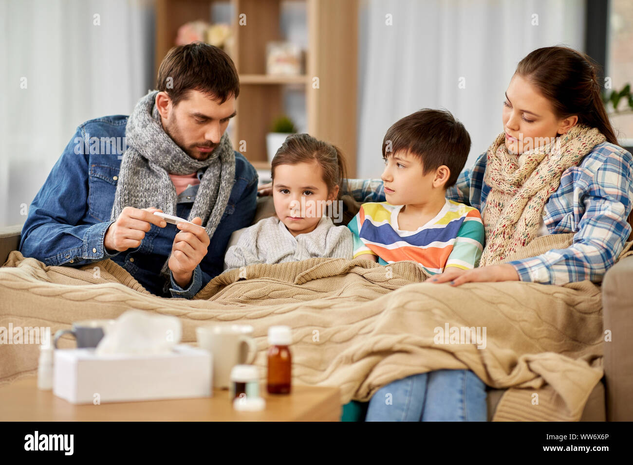 family with ill children having fever at home Stock Photo - Alamy