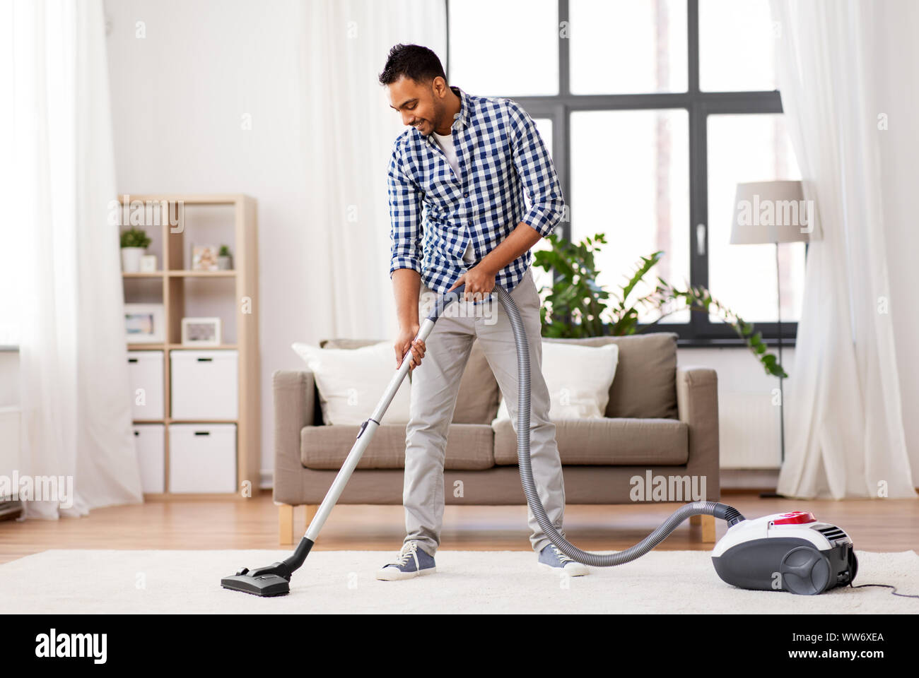 indian man with vacuum cleaner at home Stock Photo - Alamy