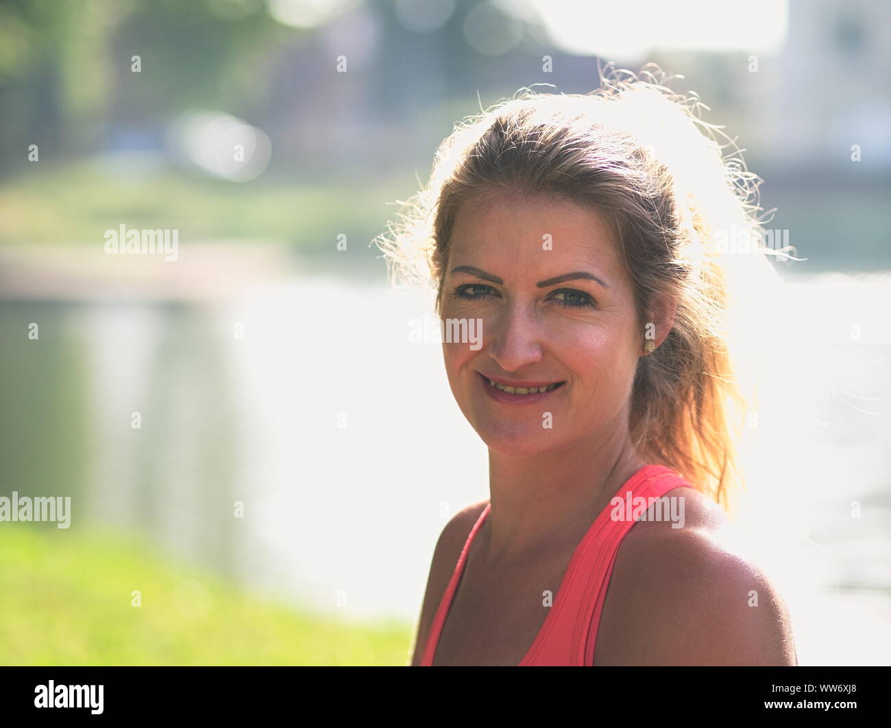 Sporty Woman in her Thirties Smiling in the Park on a Sunny Summer Day Stock Photo - Alamy