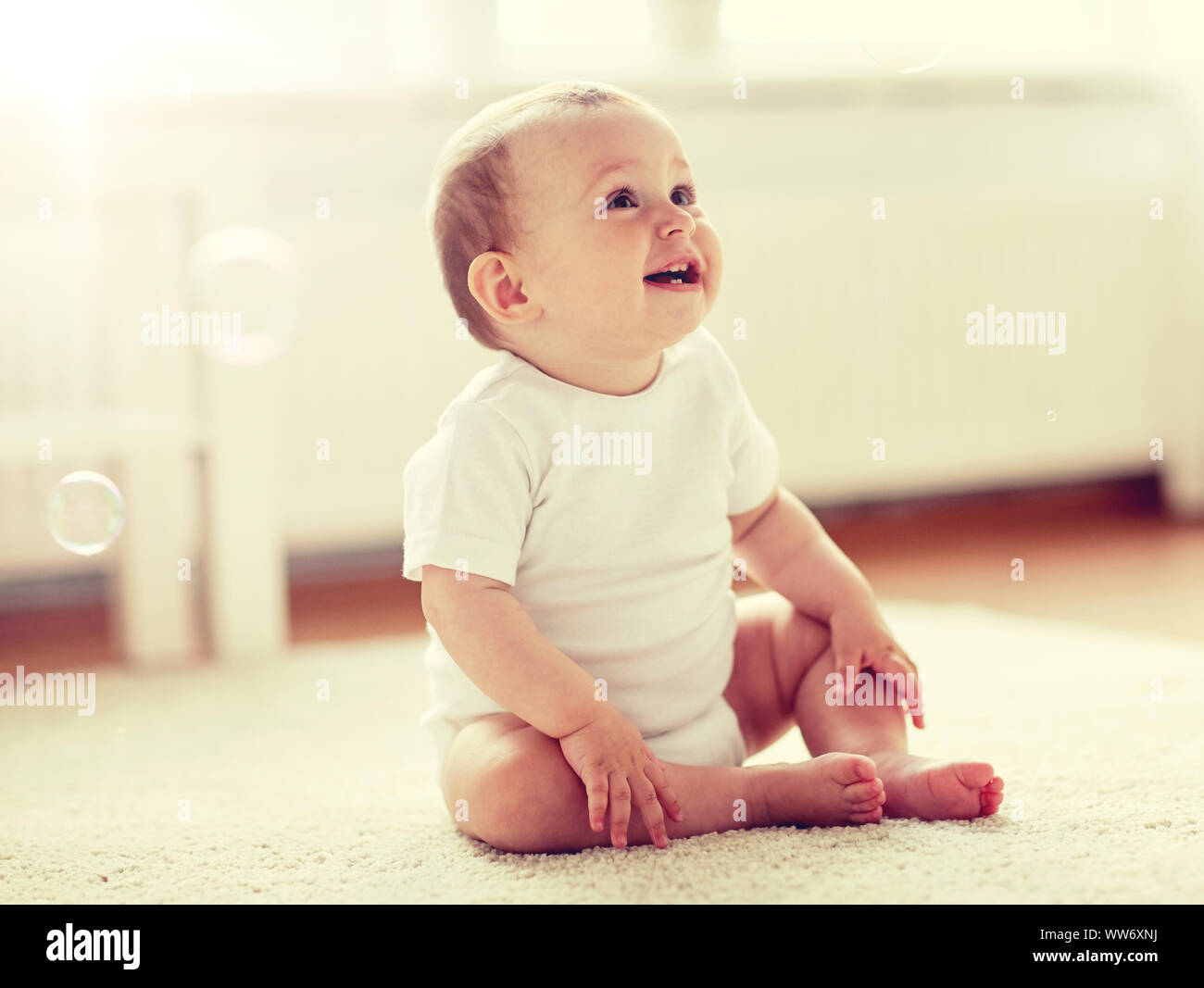 happy baby with soap bubbles at home Stock Photo - Alamy
