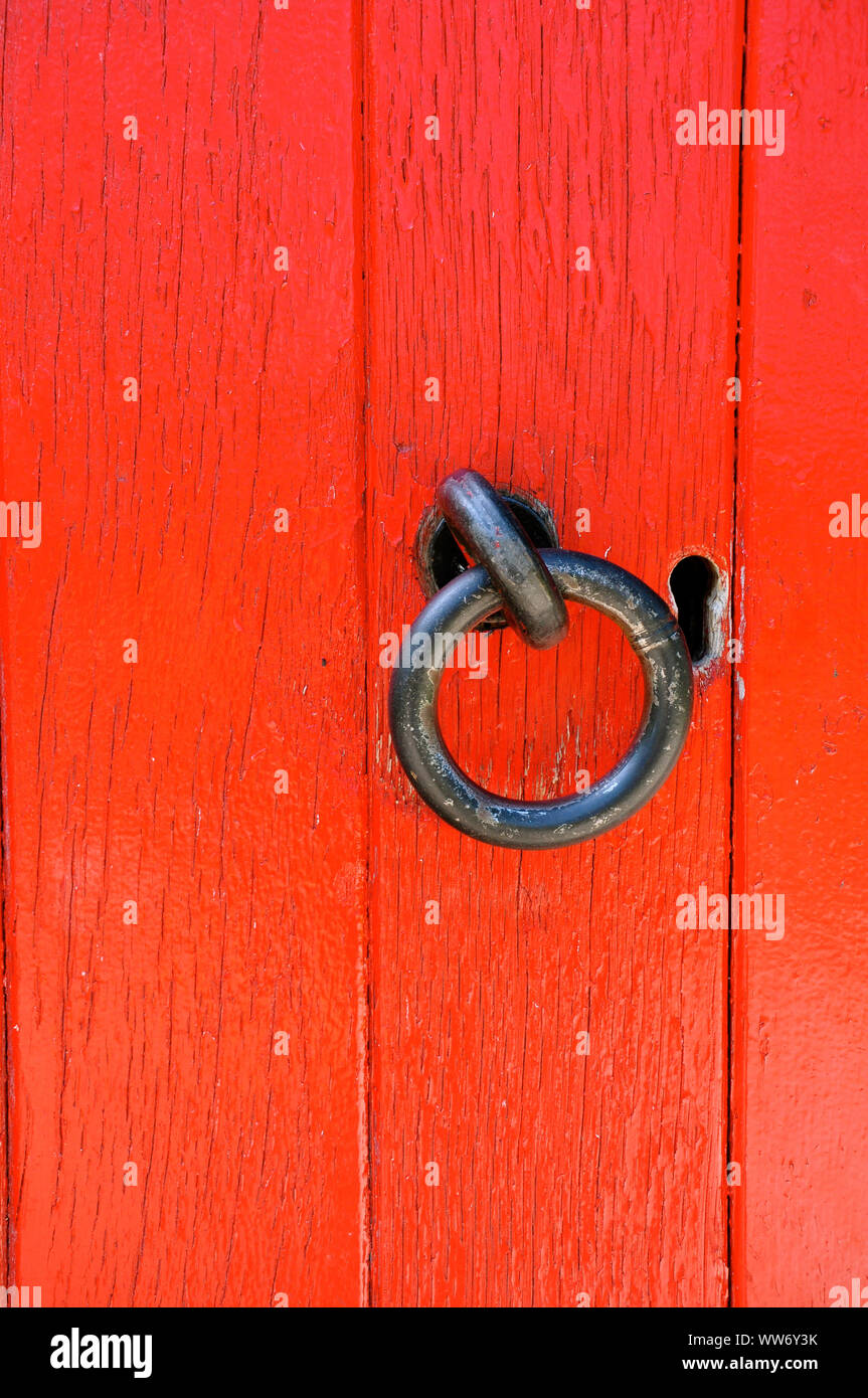 Close up of an old red door lighthouse door and its hardware creates an ...