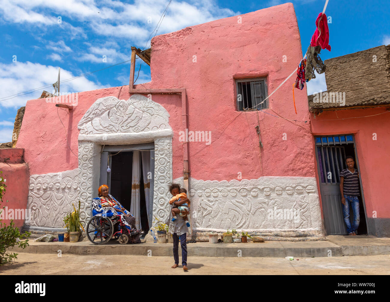 Disabled woman in front of a traditional house in the old town, Harari ...