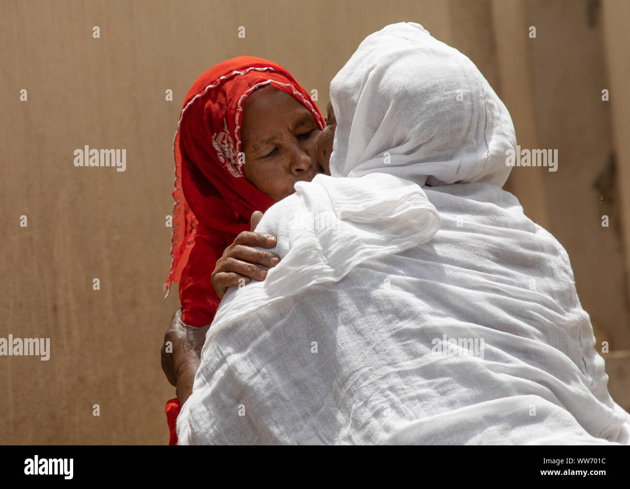 Muslim woman kissing an orthodox woman in the street, Harari region ...