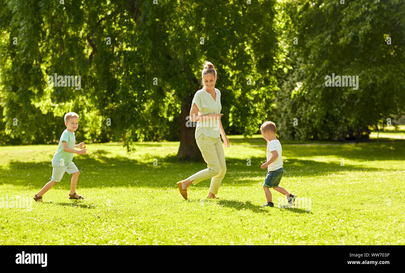 mother with sons playing catch game at summer park Stock Photo - Alamy