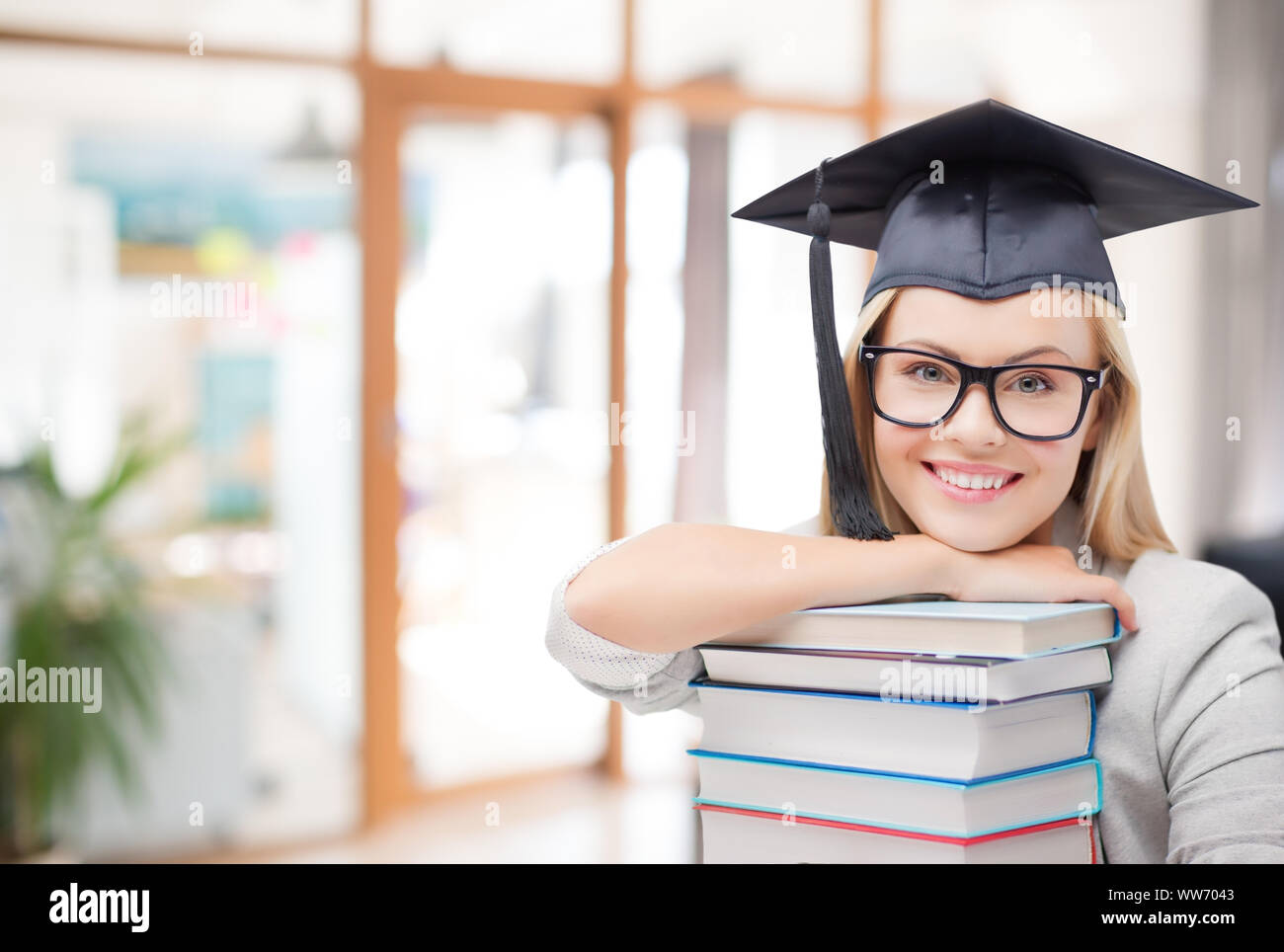 graduate student girl in bachelor hat with books Stock Photo - Alamy