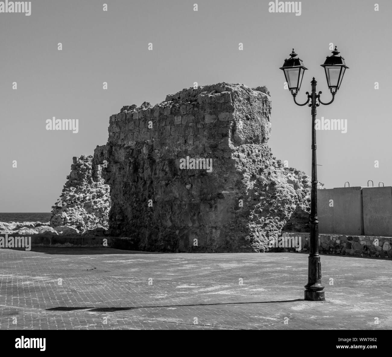 A black and white picture of the ruins of an ancient fort next to the ...