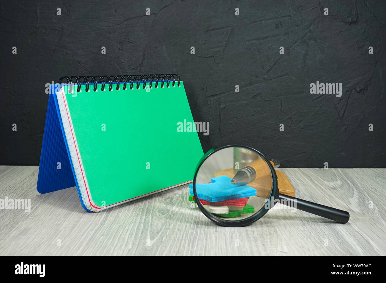 Colorful stacked jigsaw puzzle pieces viewed enlarged through a ...