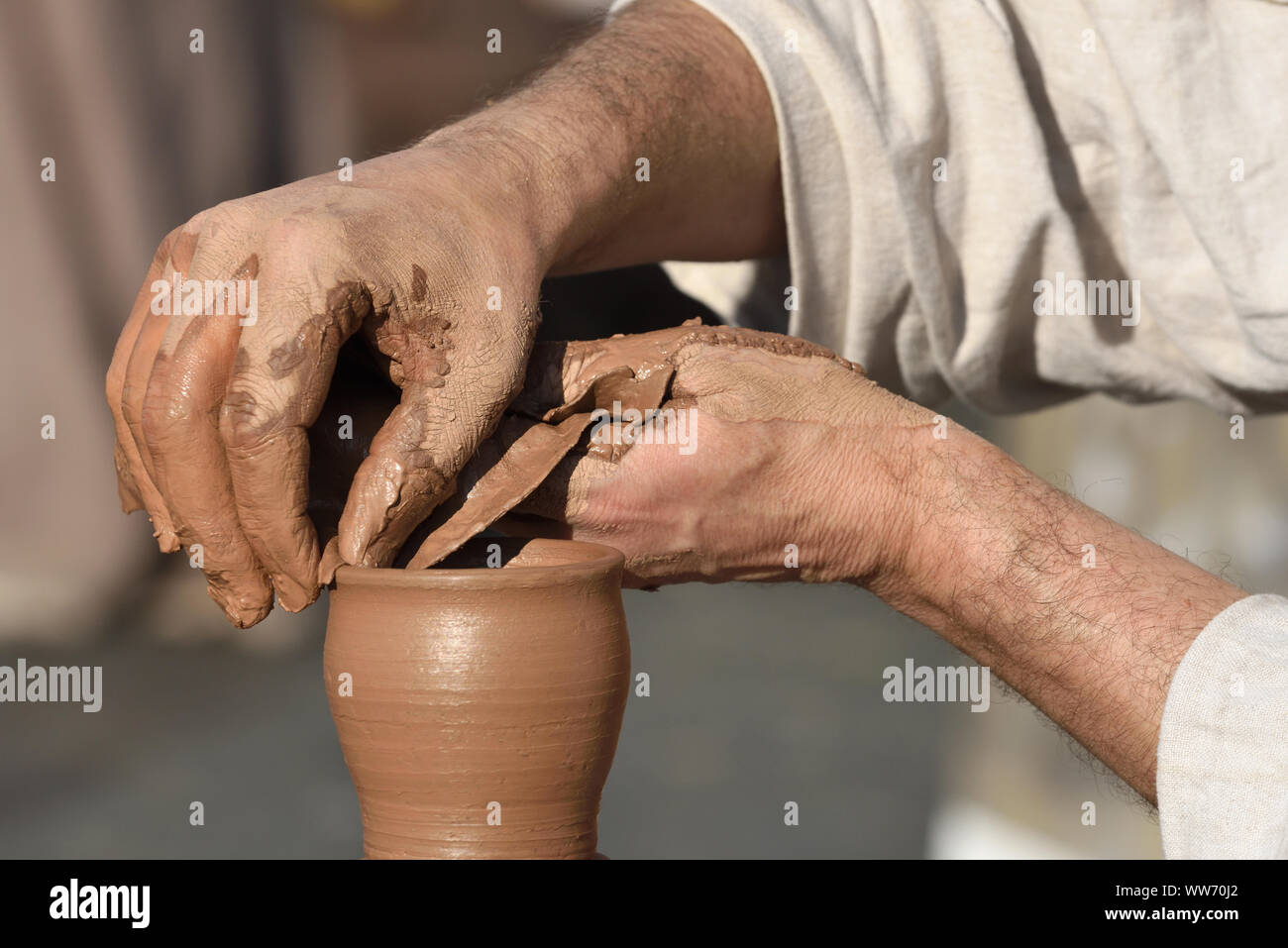 Pottery male ceramist creates a hand made clay product. Process of ...