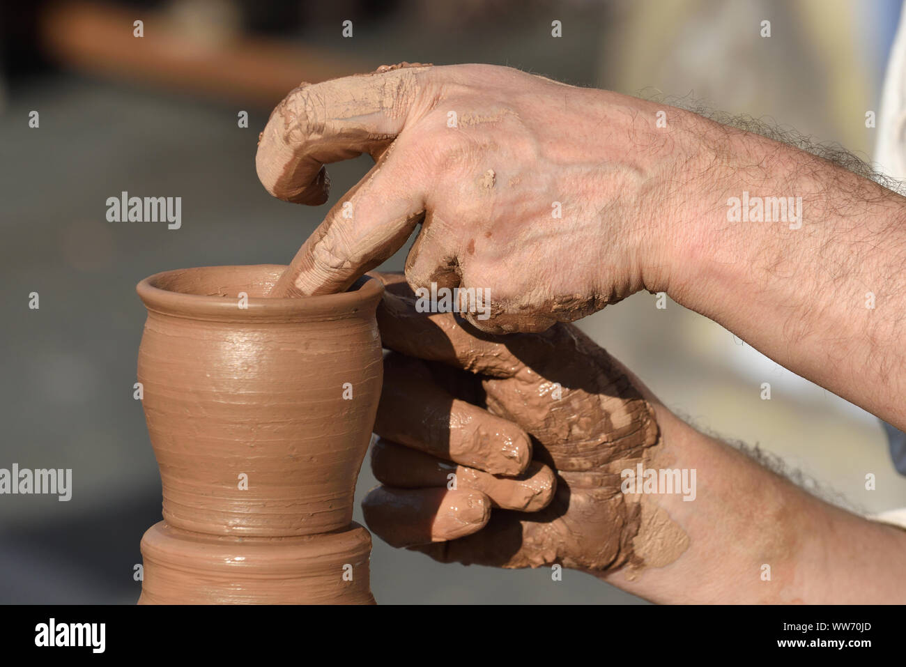 Pottery male ceramist creates a hand made clay product. Process of ...