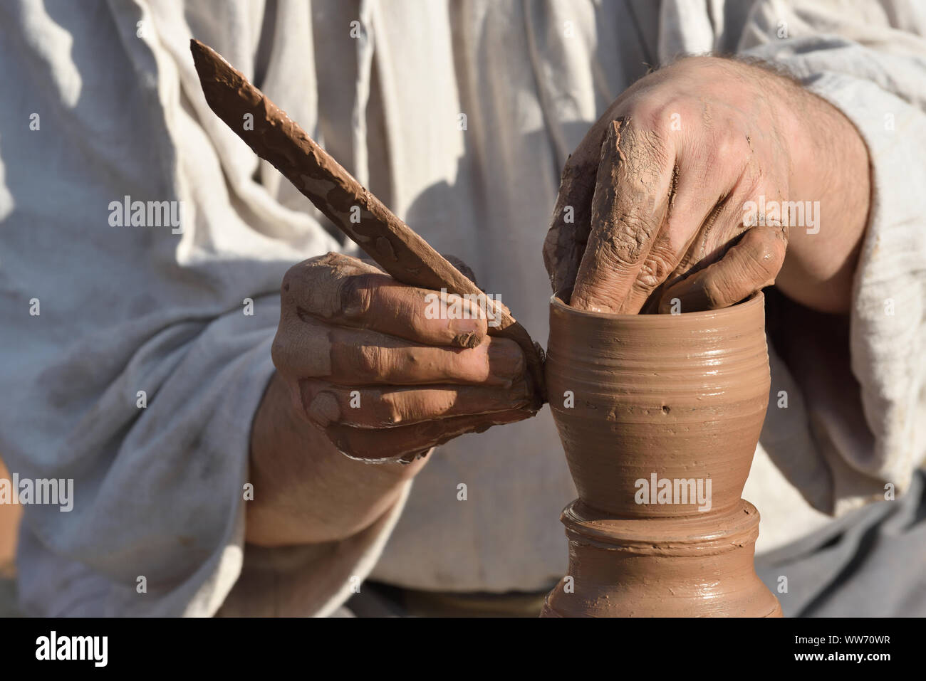 Pottery male ceramist creates a hand made clay product. Process of ...