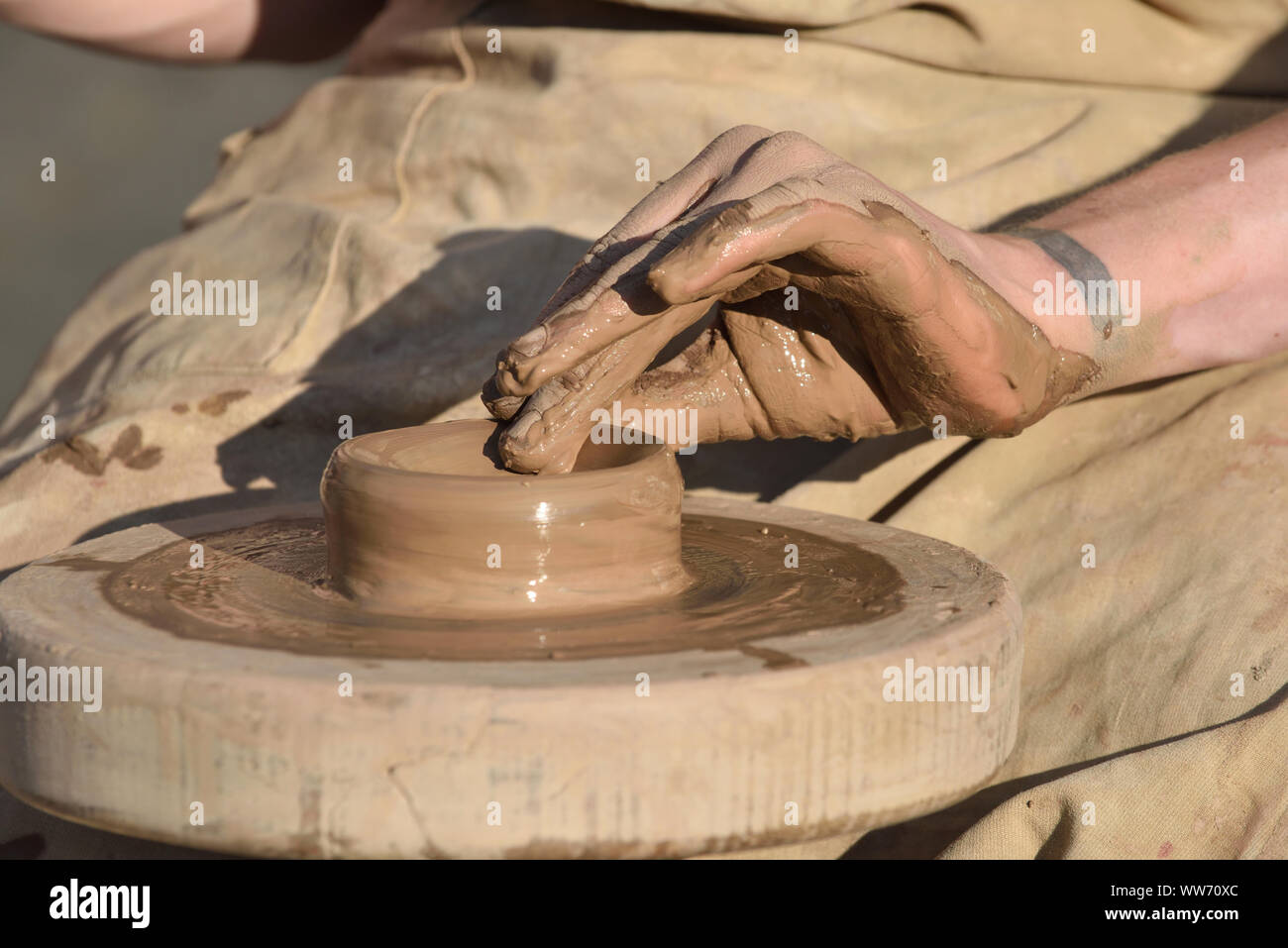 Pottery male ceramist creates a hand made clay product. Process of ...