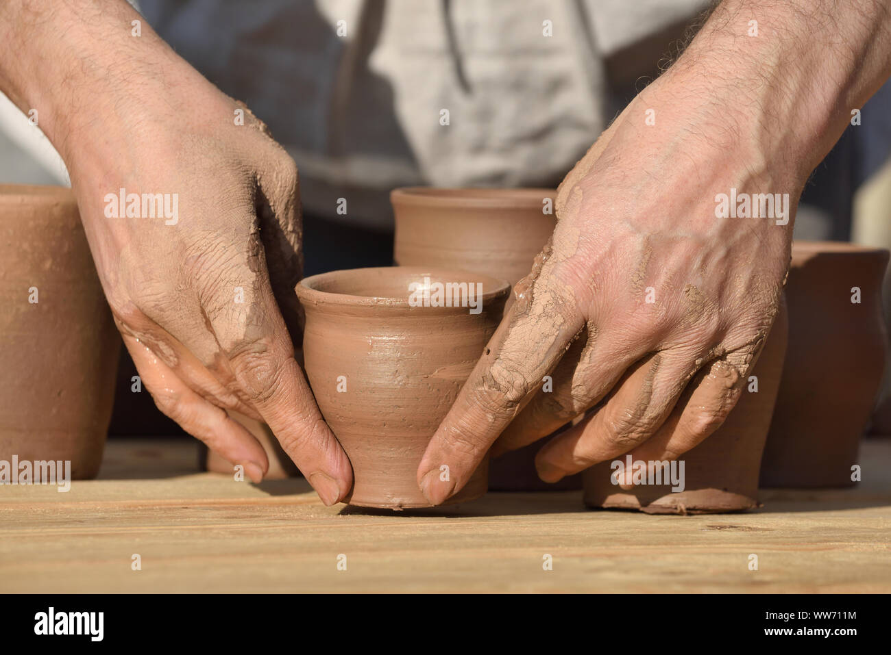 Pottery male ceramist creates a hand made clay product. Process of ...