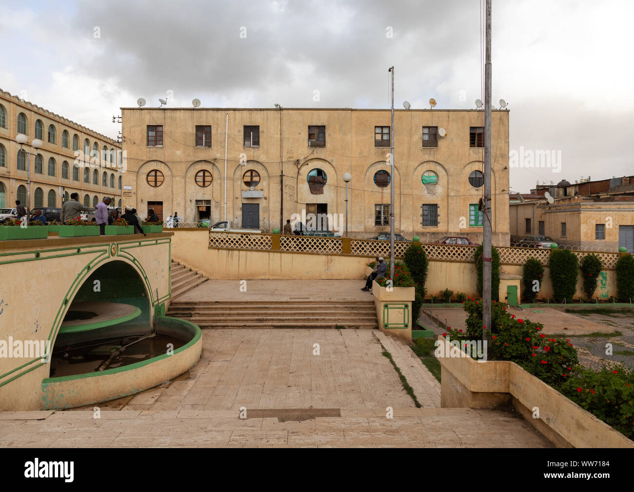 Exterior of old novecento style building and a fountain from the ...