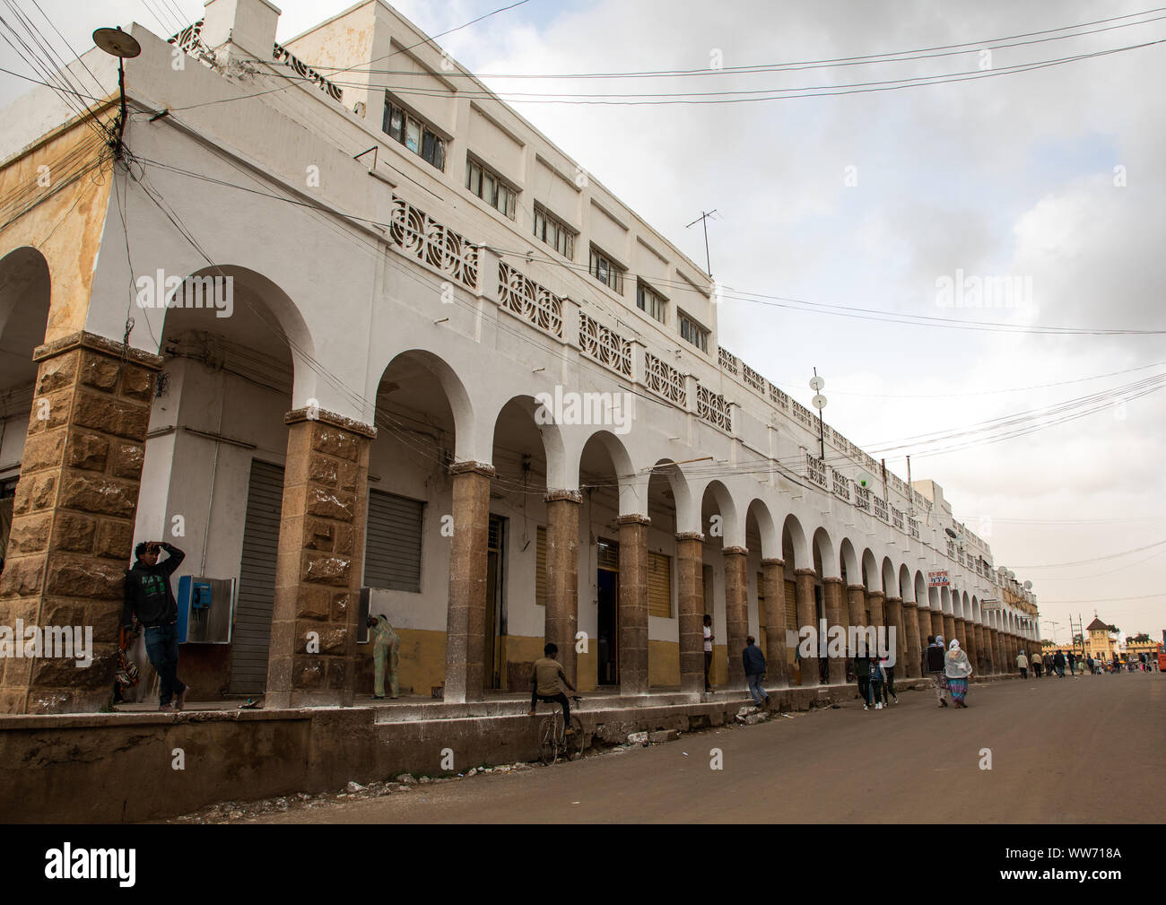 Old art deco style building with arches from the italian colonial times ...