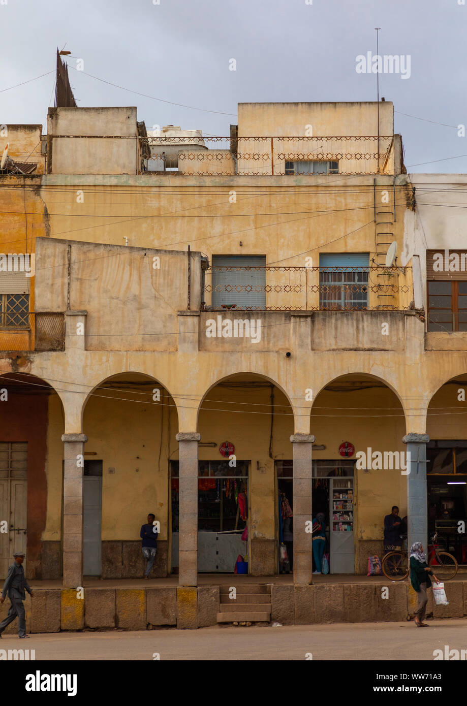 Old art deco style building with arches from the italian colonial times ...
