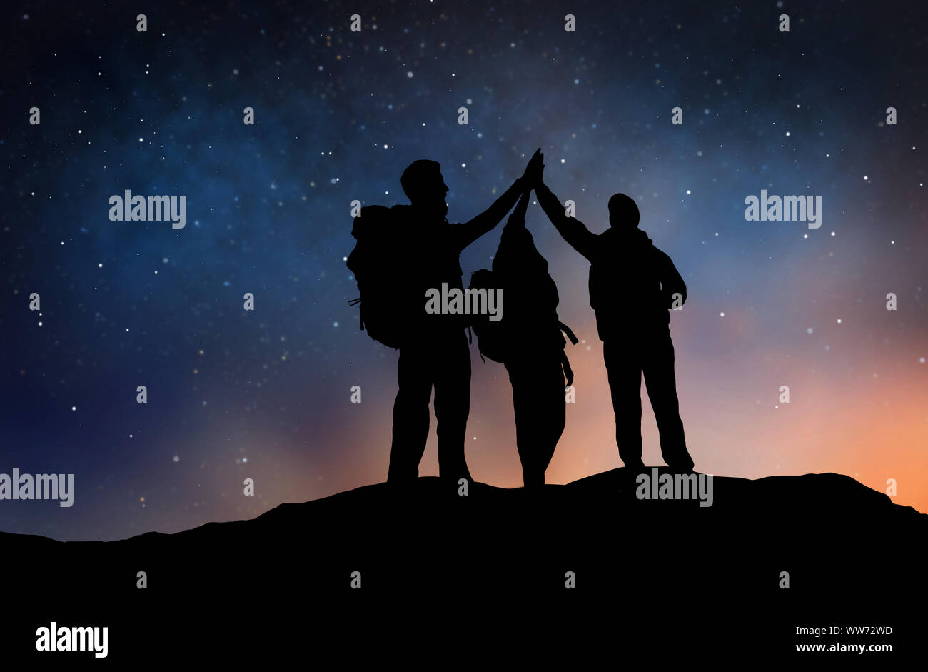 travelers making high five over starry night sky Stock Photo - Alamy