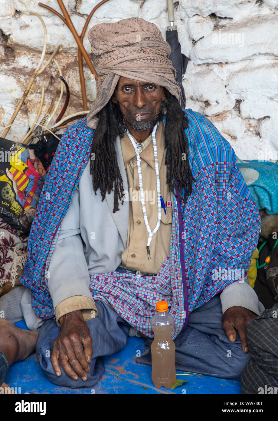 Oromo pilgrim man with a holy water bottle in Sheikh Hussein shrine ...
