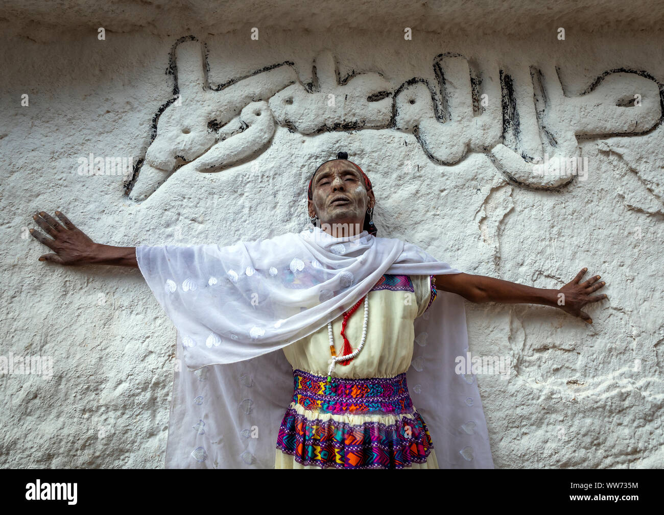 Oromo pilgrim woman in Sheikh Hussein shrine with jarawa powder on the ...