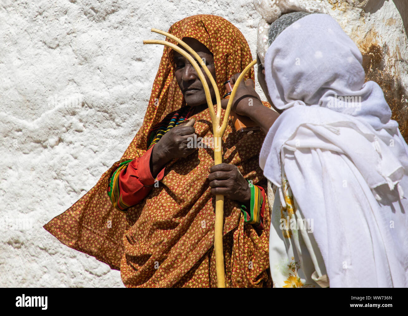 Woman putting perfume on an oromo pilgrim in Sheikh Hussein shrine ...